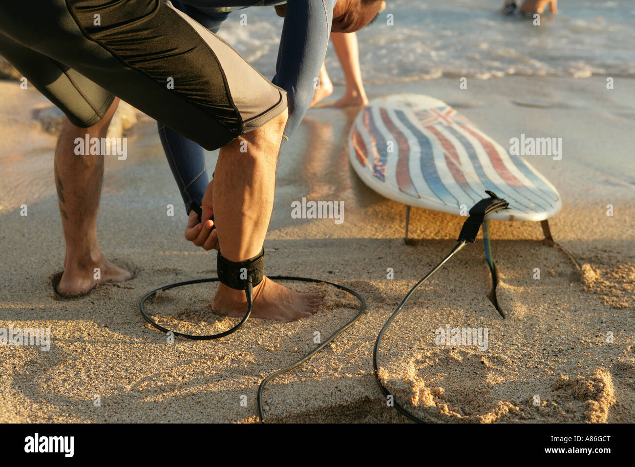 A surf boarder is getting ready for surfboarding Stock Photo - Alamy
