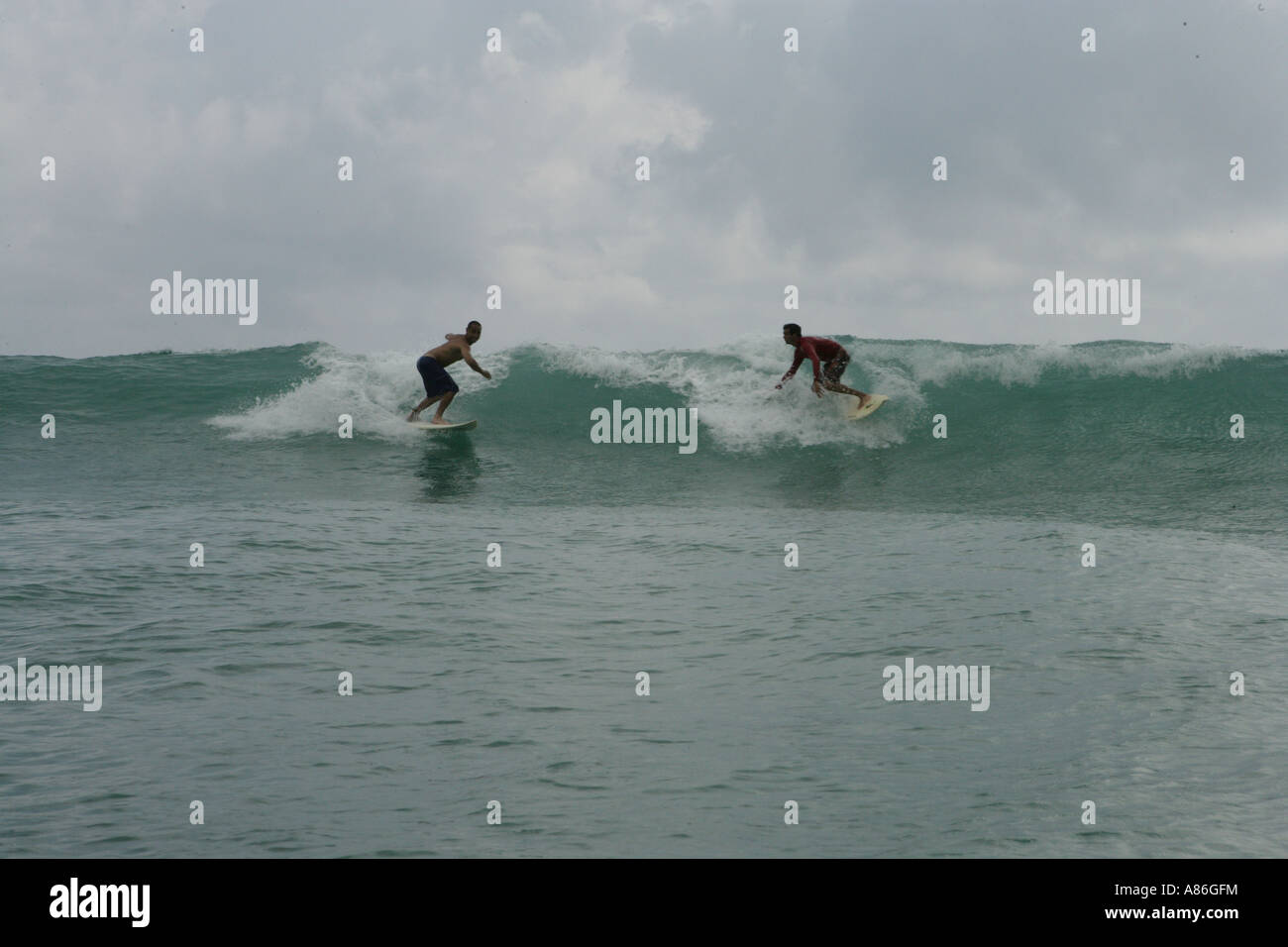 Two men surfboarding Stock Photo - Alamy
