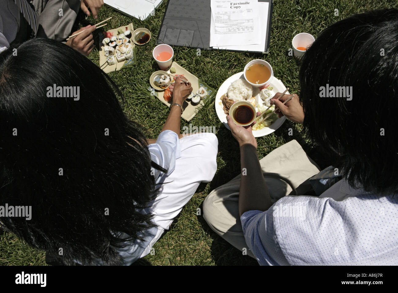 View of three colleagues having lunch together Stock Photo - Alamy