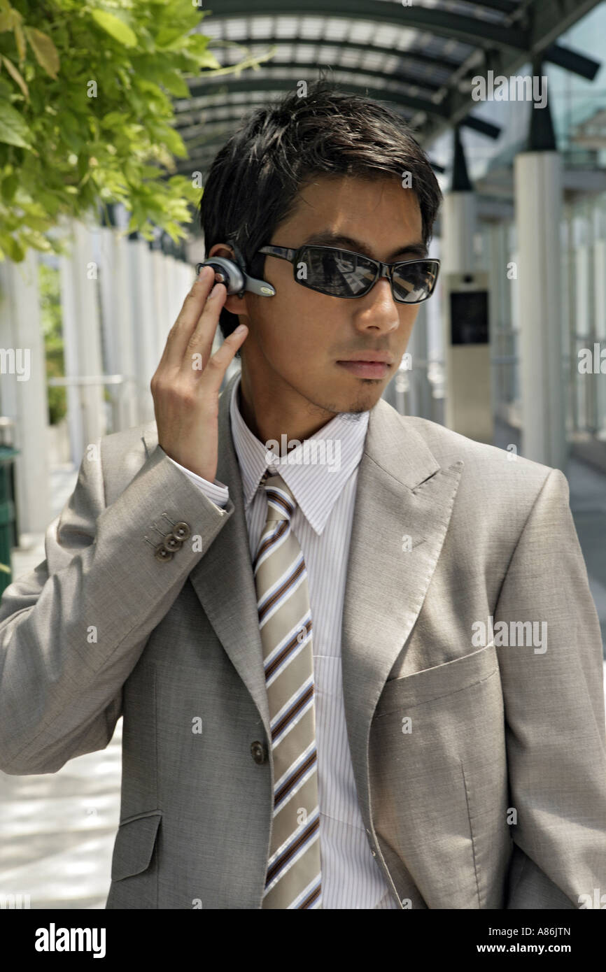 Using wireless earpiece hi-res stock photography and images - Alamy