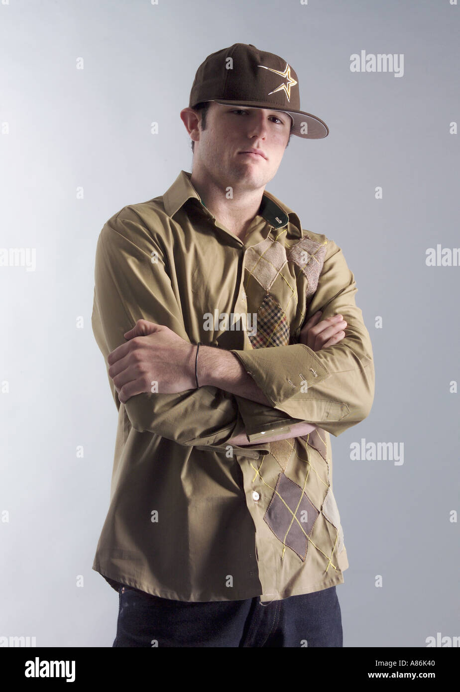 Young handsome male model poses in baseball cap and casual clothes ...