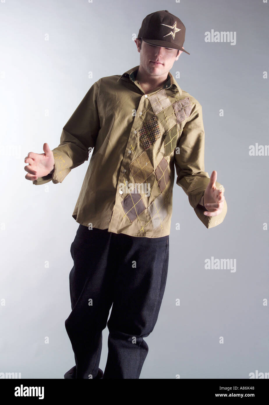 Young handsome male model poses in baseball cap and casual clothes ...