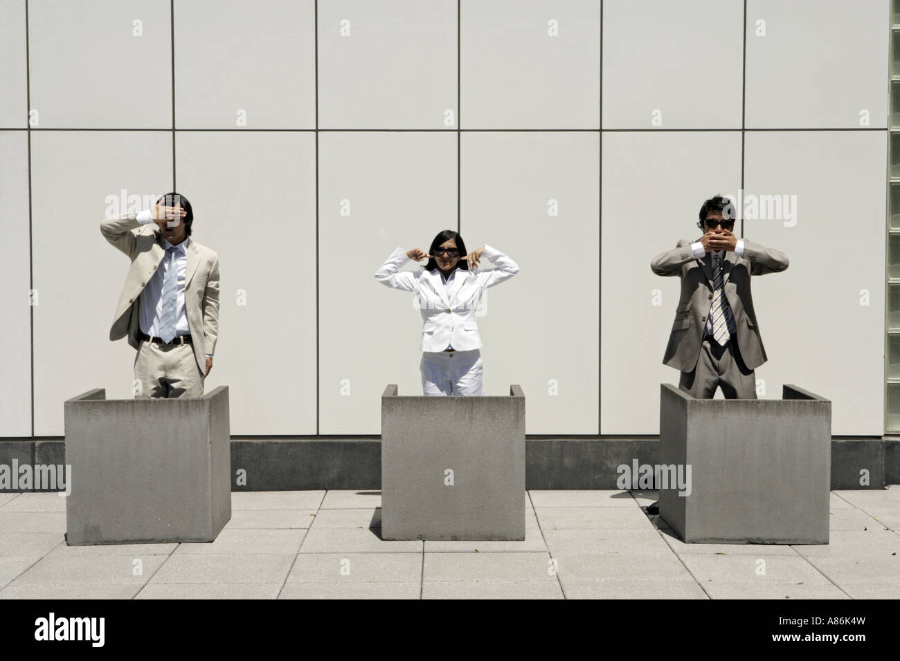 Three executives are standing outside an office building Stock Photo ...