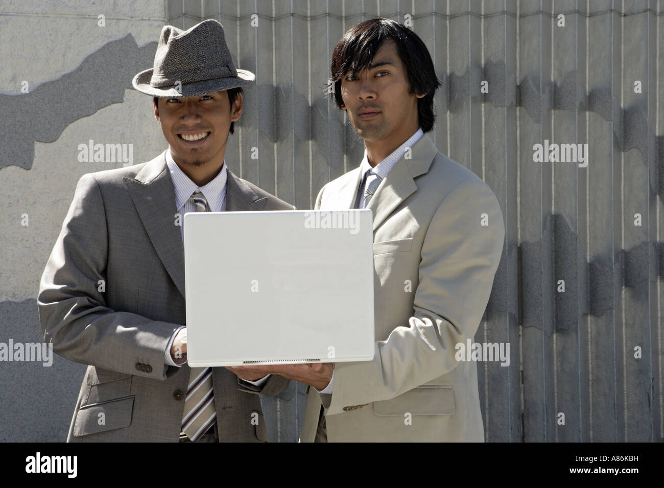 Portrait of two men with a laptop Stock Photo - Alamy