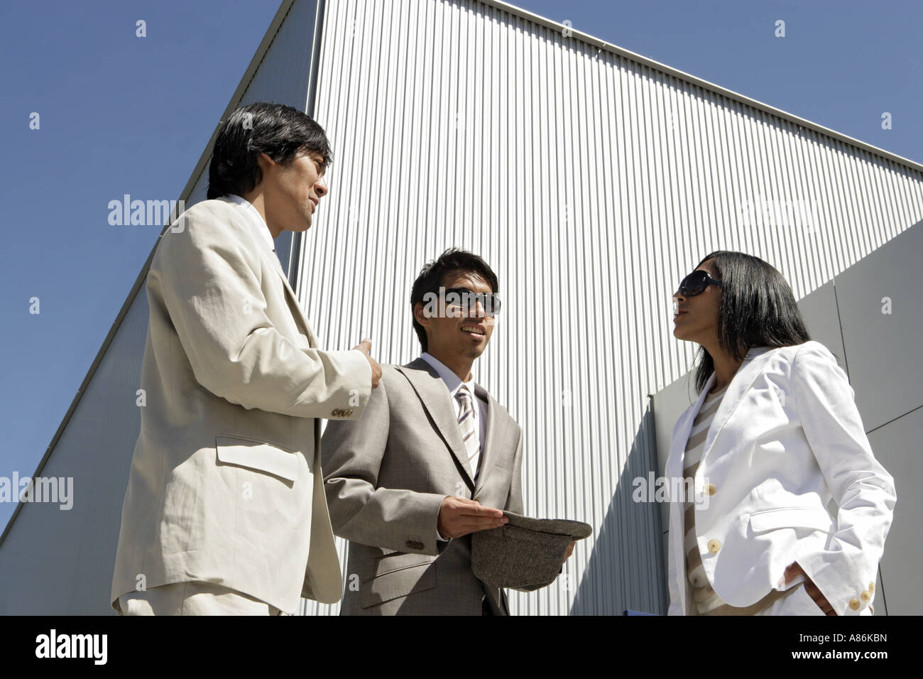Three executives are in a conversation Stock Photo - Alamy
