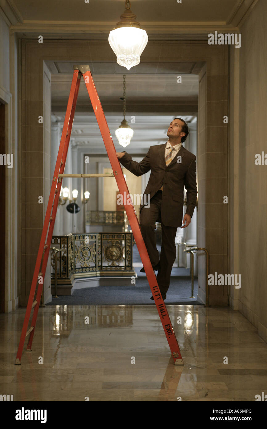 Holding ladder for colleague hi-res stock photography and images - Alamy