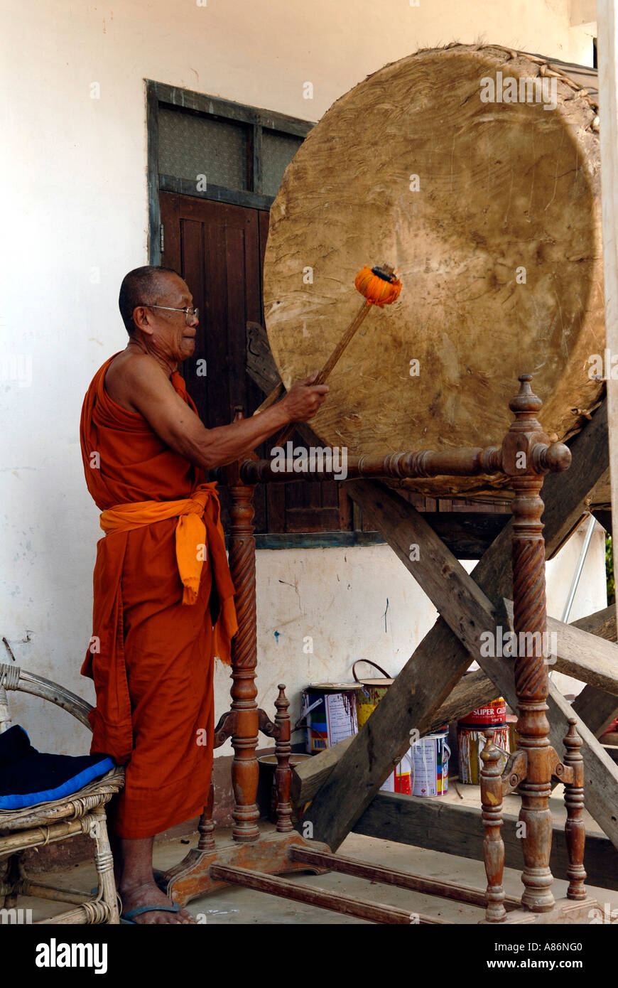 Monk beating drum Ban Phatang Central Laos Stock Photo - Alamy