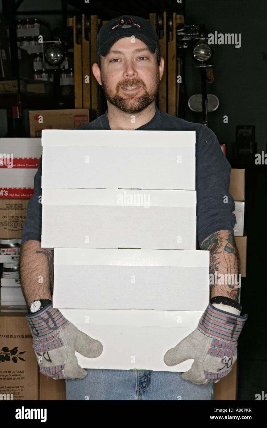 View of a man holding white boxes Stock Photo - Alamy
