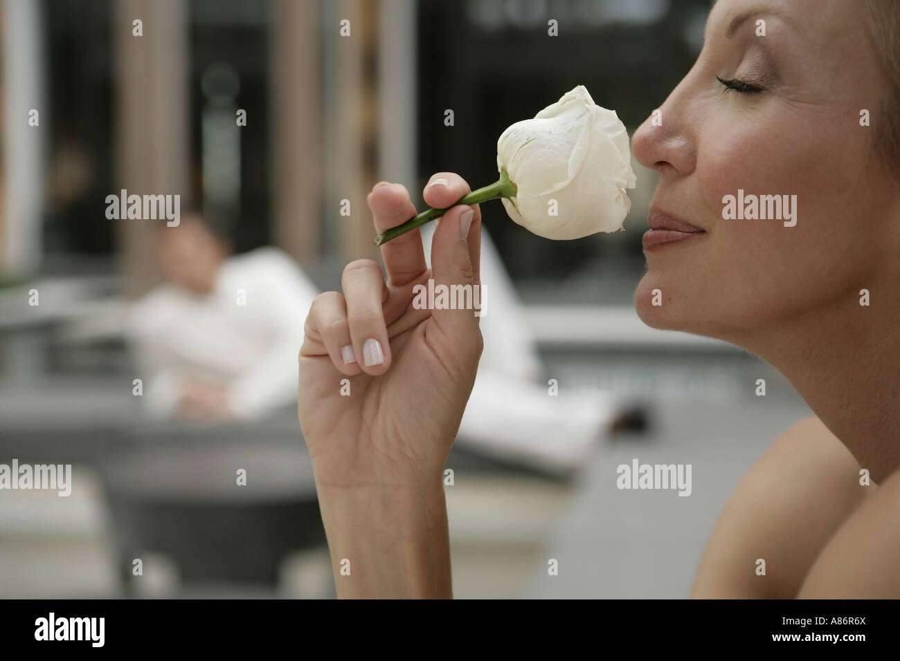 Woman smelling rose petals hi-res stock photography and images - Alamy