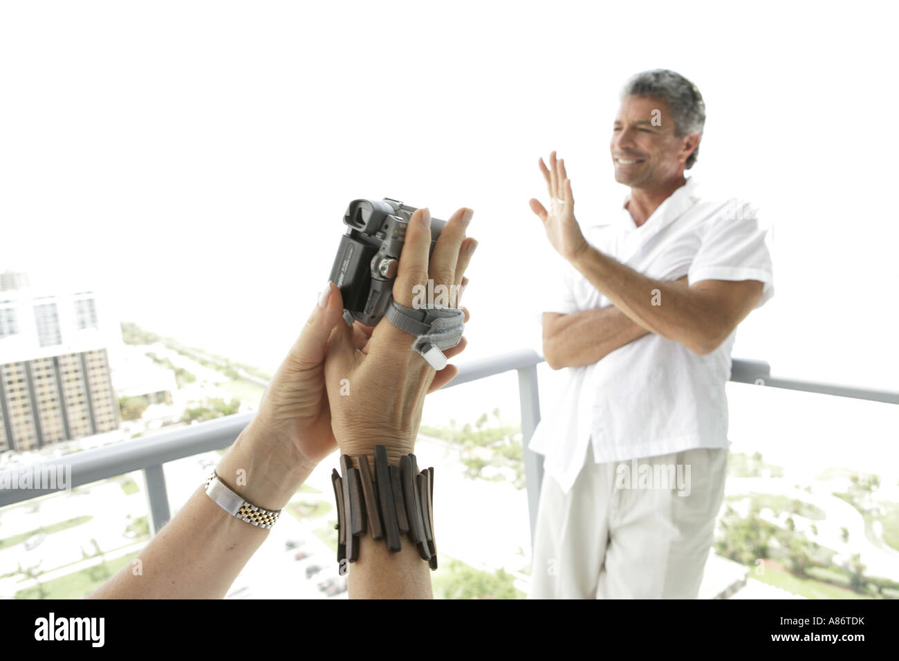 View of woman's hand filming a man Stock Photo - Alamy