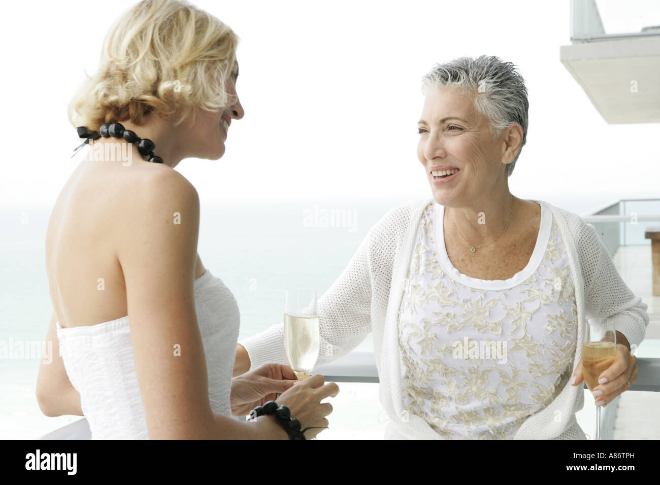 Two women talking Stock Photo - Alamy