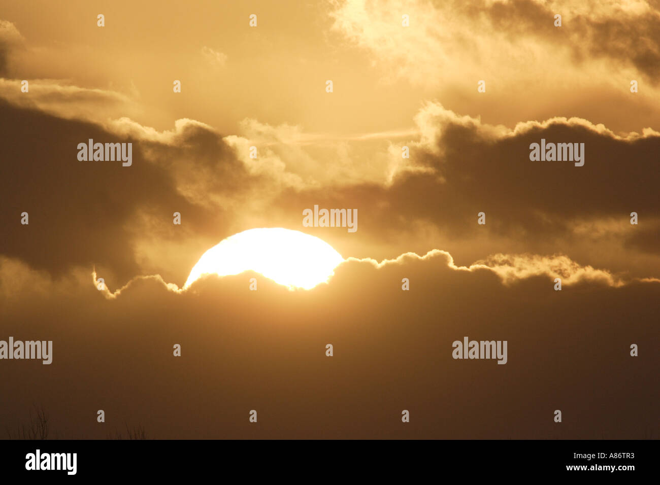 Sunsetting behind the clouds hi-res stock photography and images - Alamy