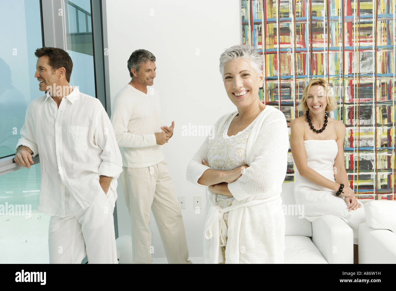 Group of four mature adults all dressed in white Stock Photo - Alamy