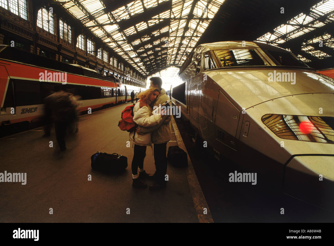 Couple saying goodbye next to SNCF high speed train at Gare du Lyon in ...