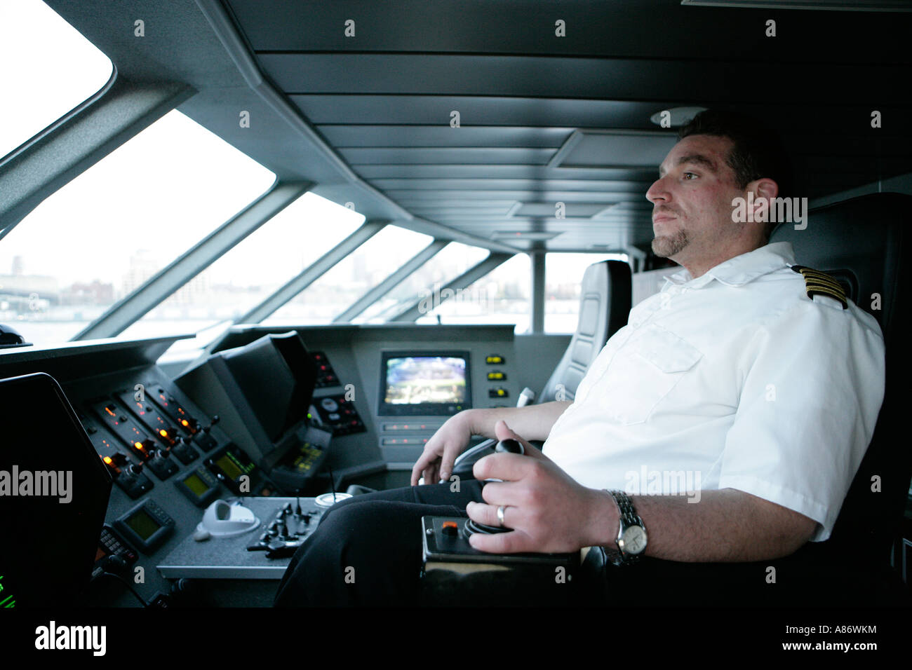Person driving a boat Stock Photo - Alamy