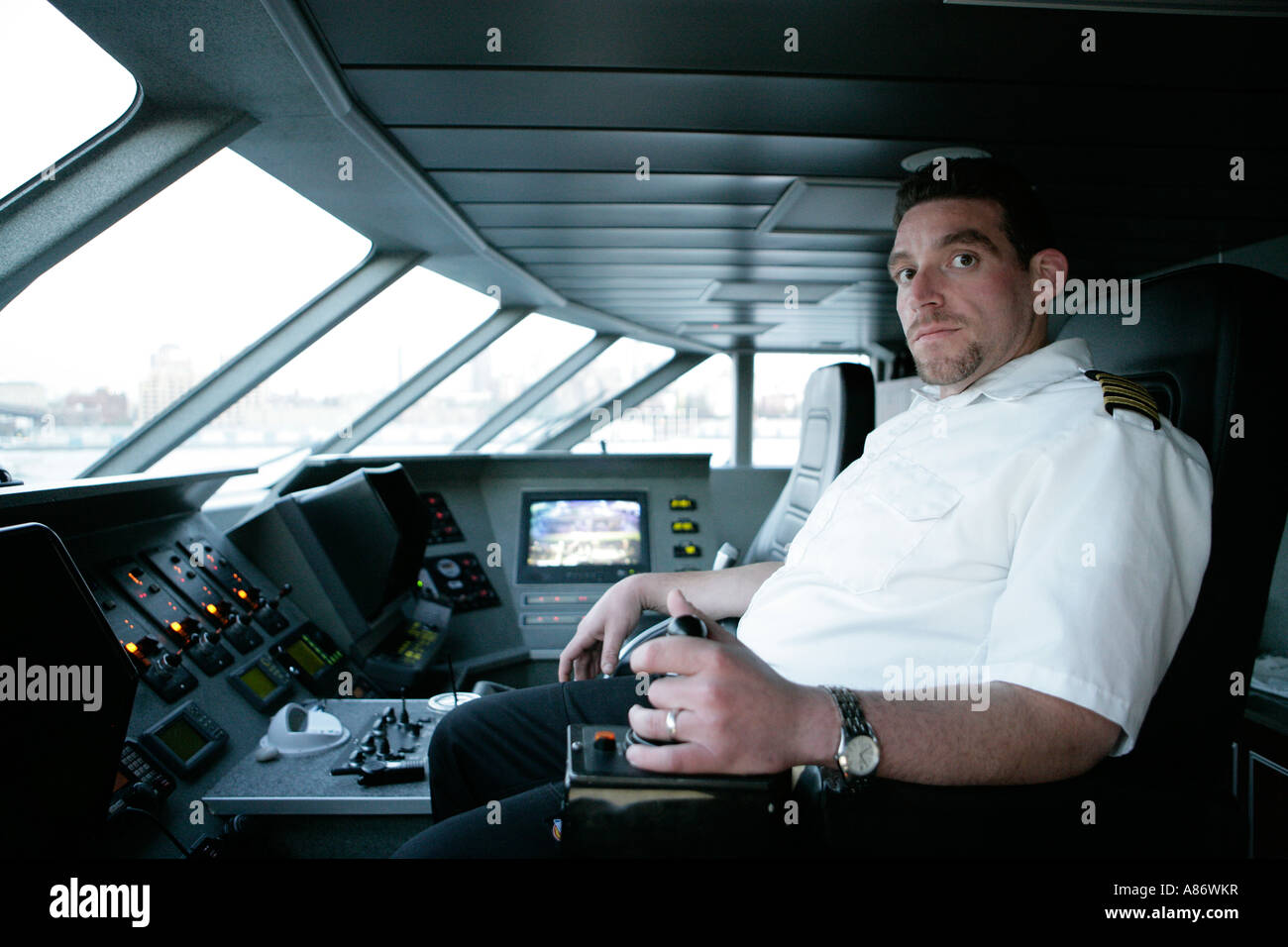 Person driving a boat Stock Photo - Alamy