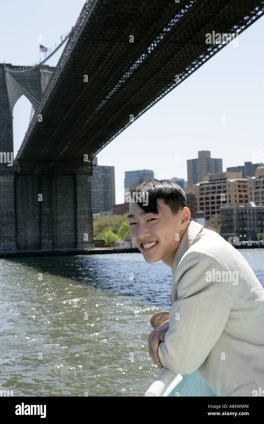 Man leaning on a railing Stock Photo - Alamy