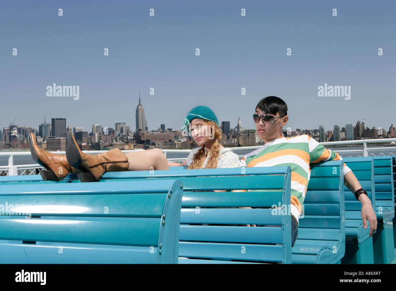 Two people sitting on benches Stock Photo - Alamy