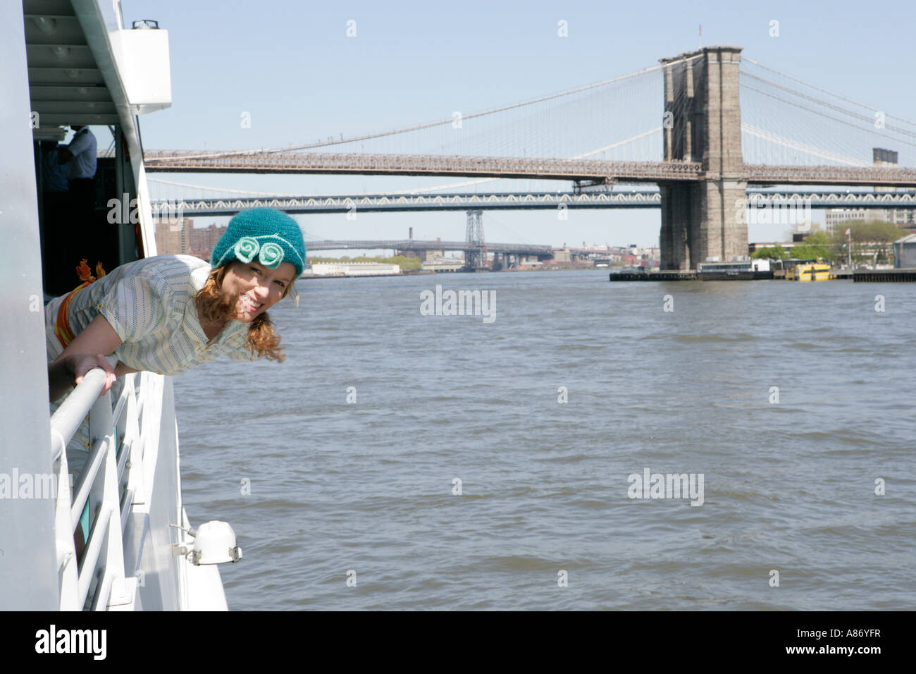 Woman leaning over railing of a boat Stock Photo - Alamy