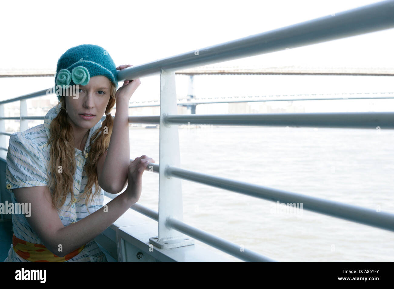 woman leaning on a railing Stock Photo - Alamy