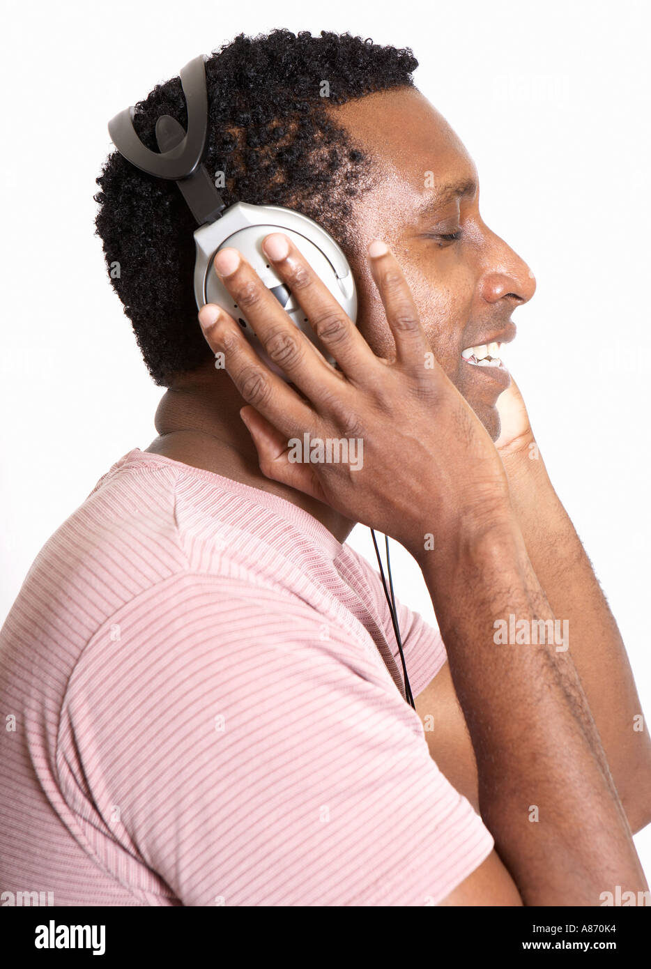 Man with both hands on head set, eyes closed, listening to music Stock ...