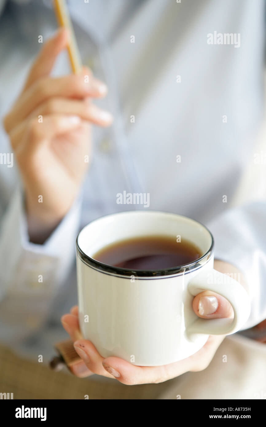 Cup of tea hold by person, close-up Stock Photo - Alamy