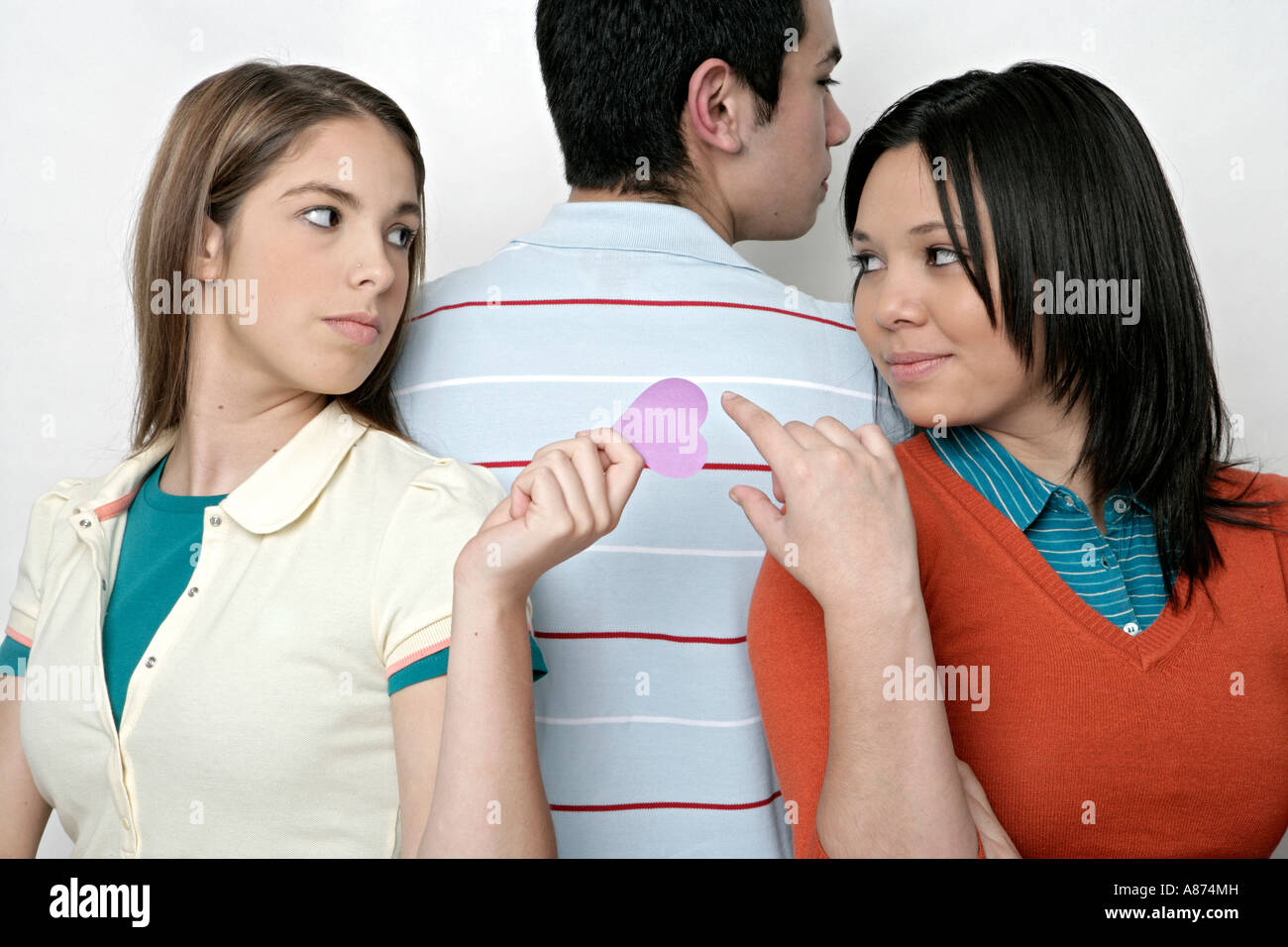 Friend passing note behind a boy's back Stock Photo - Alamy