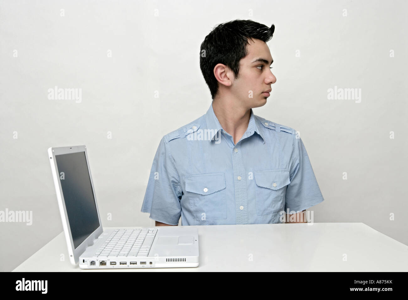 View of a teenage boy sitting at a desk with laptop Stock Photo - Alamy