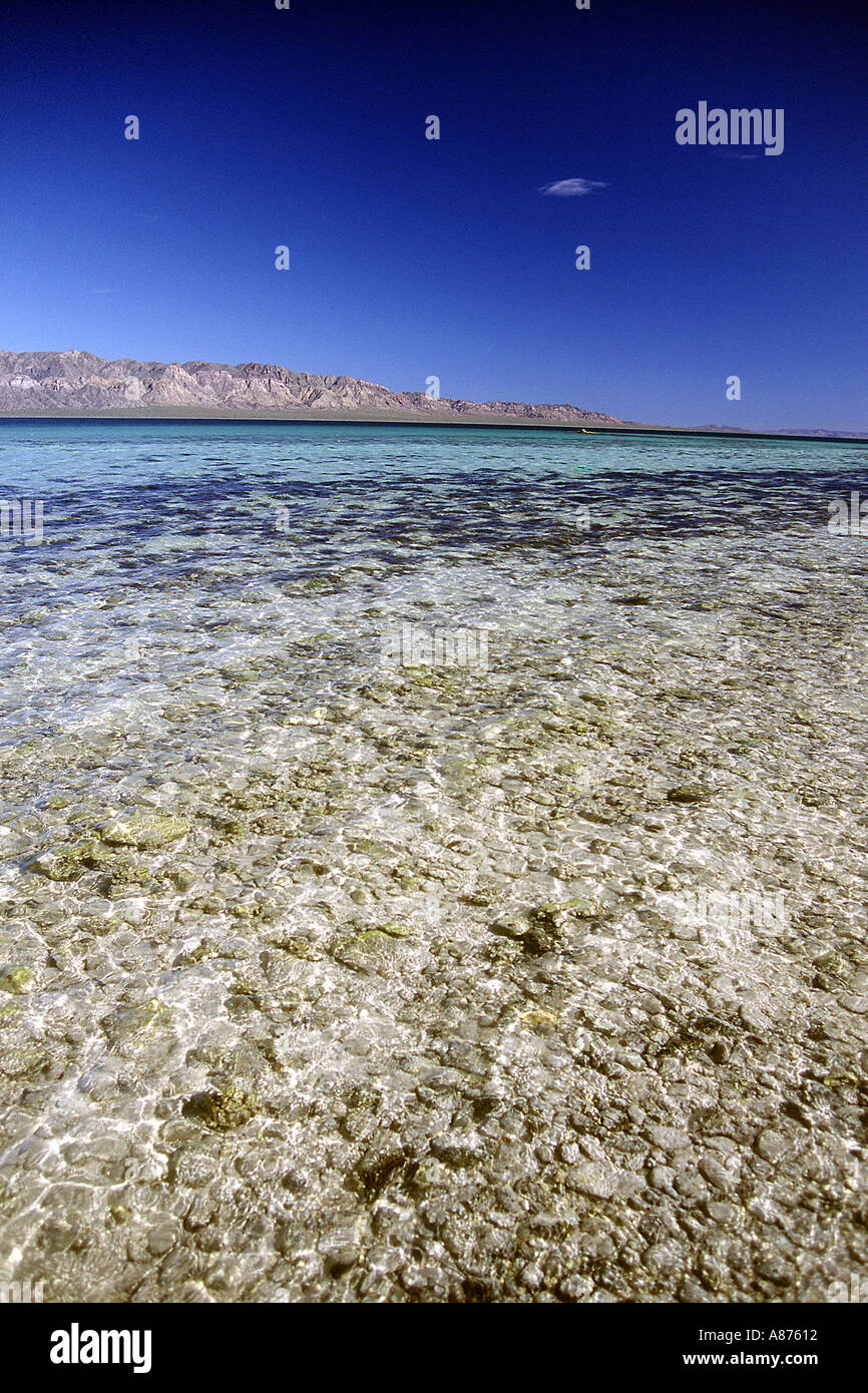 Scene of clear blue tropical waters and mountains at Bahia Concepcion ...