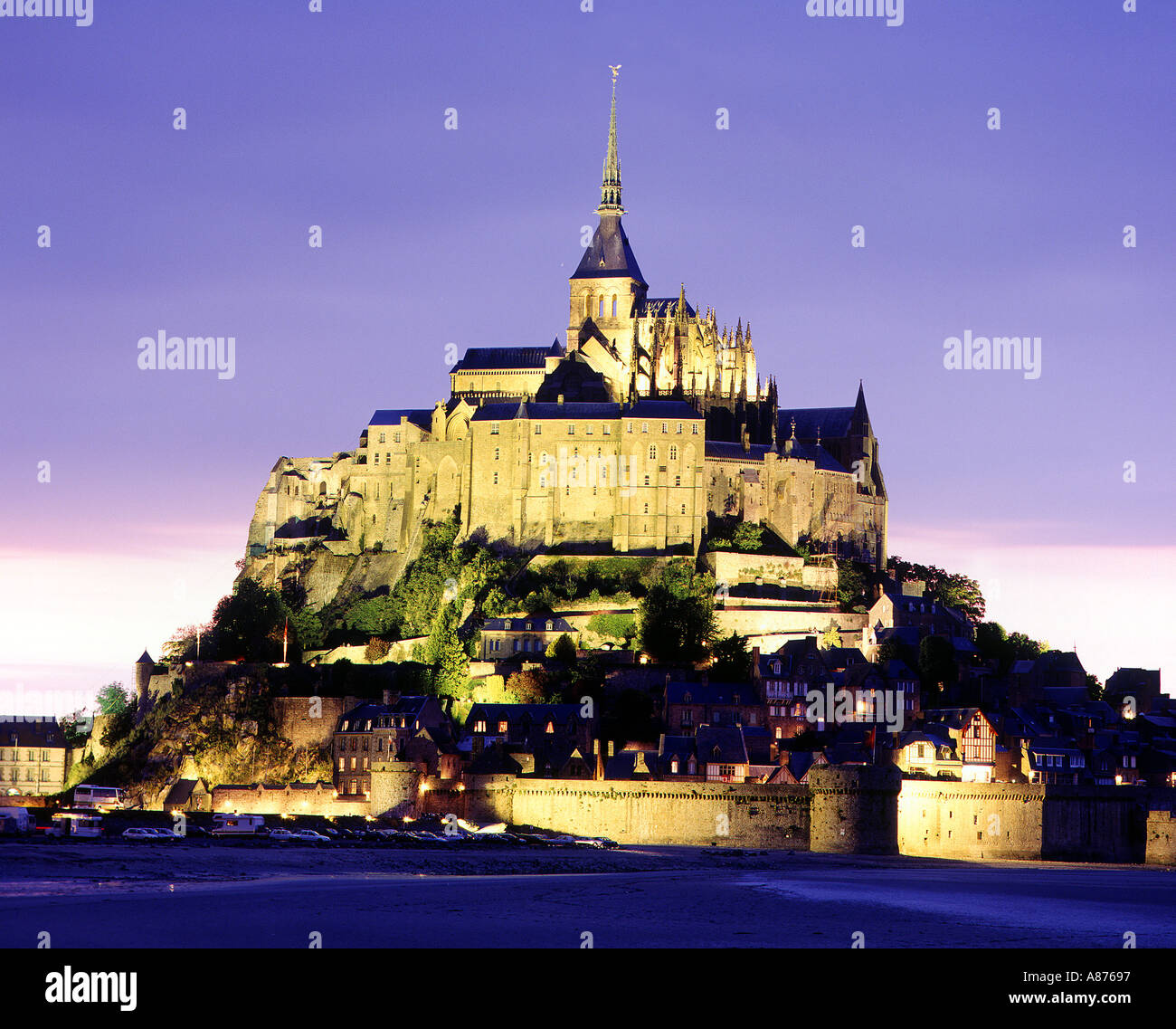 Mont St Michel on a hill at dusk with lights accenting the castles ...