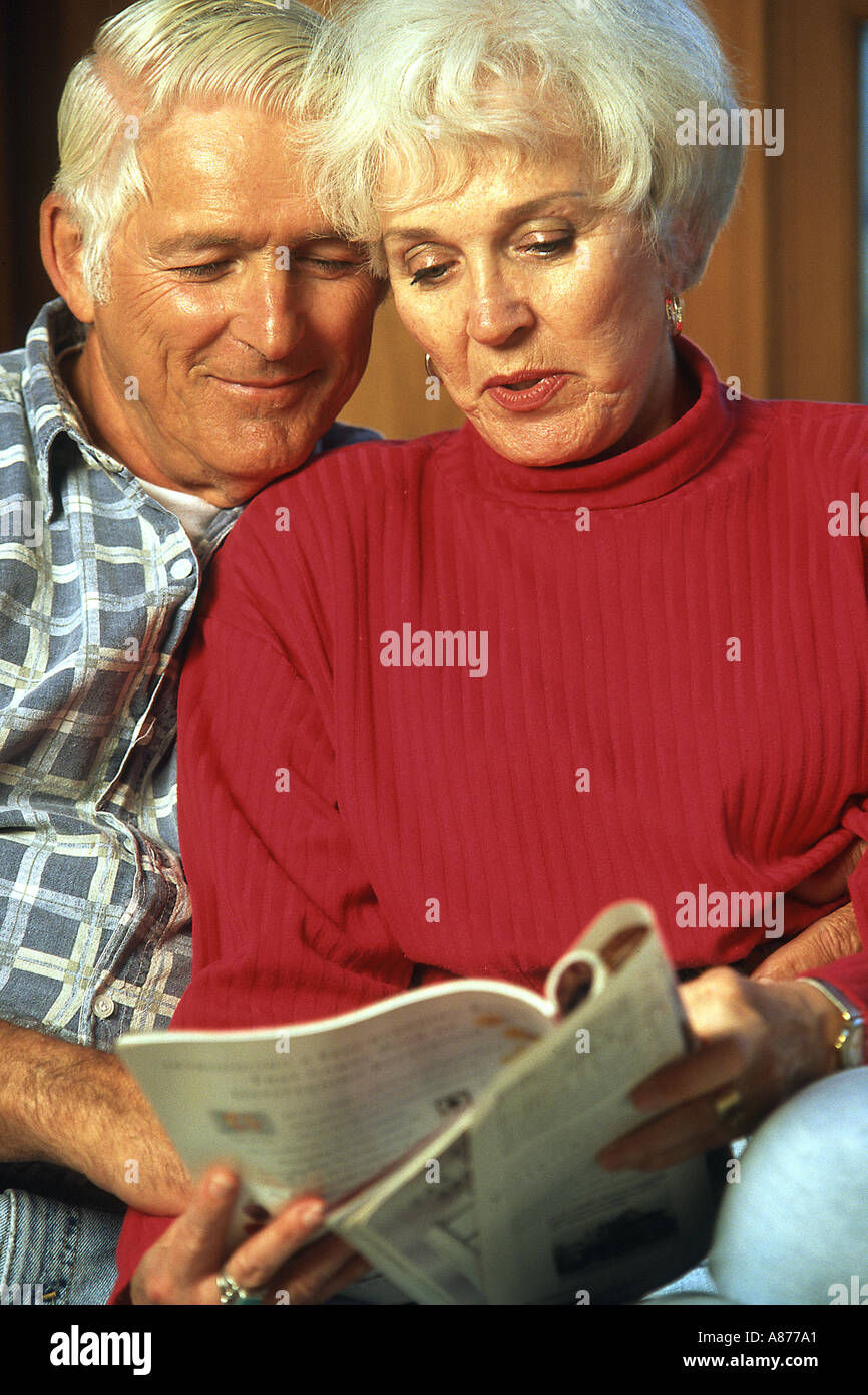 A smiling senior citizen male sitting next to a senior citizen female ...