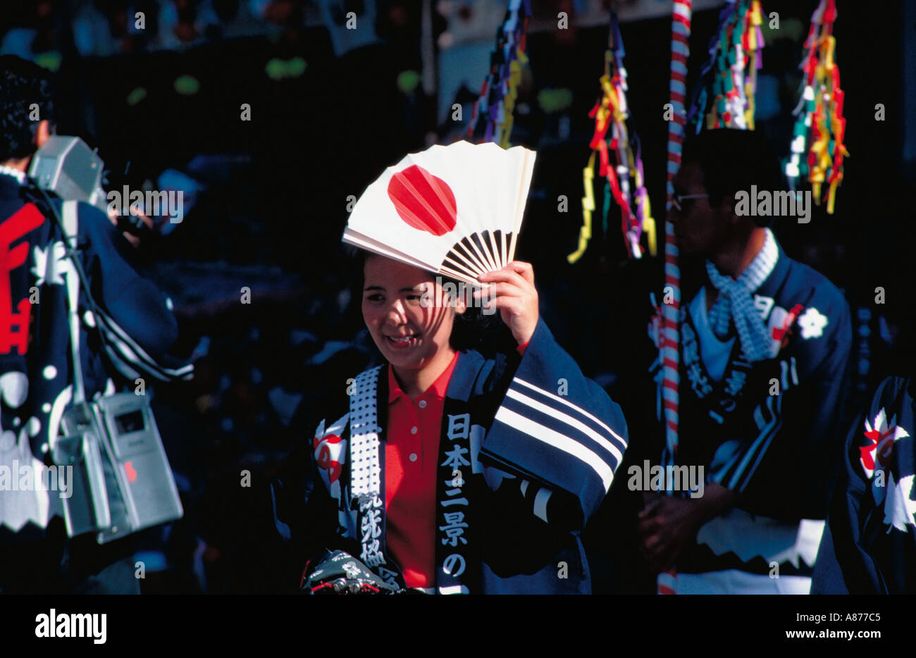 JAPAN Honshu Miyajima Island Woman at the autumn Sake Festival holding ...