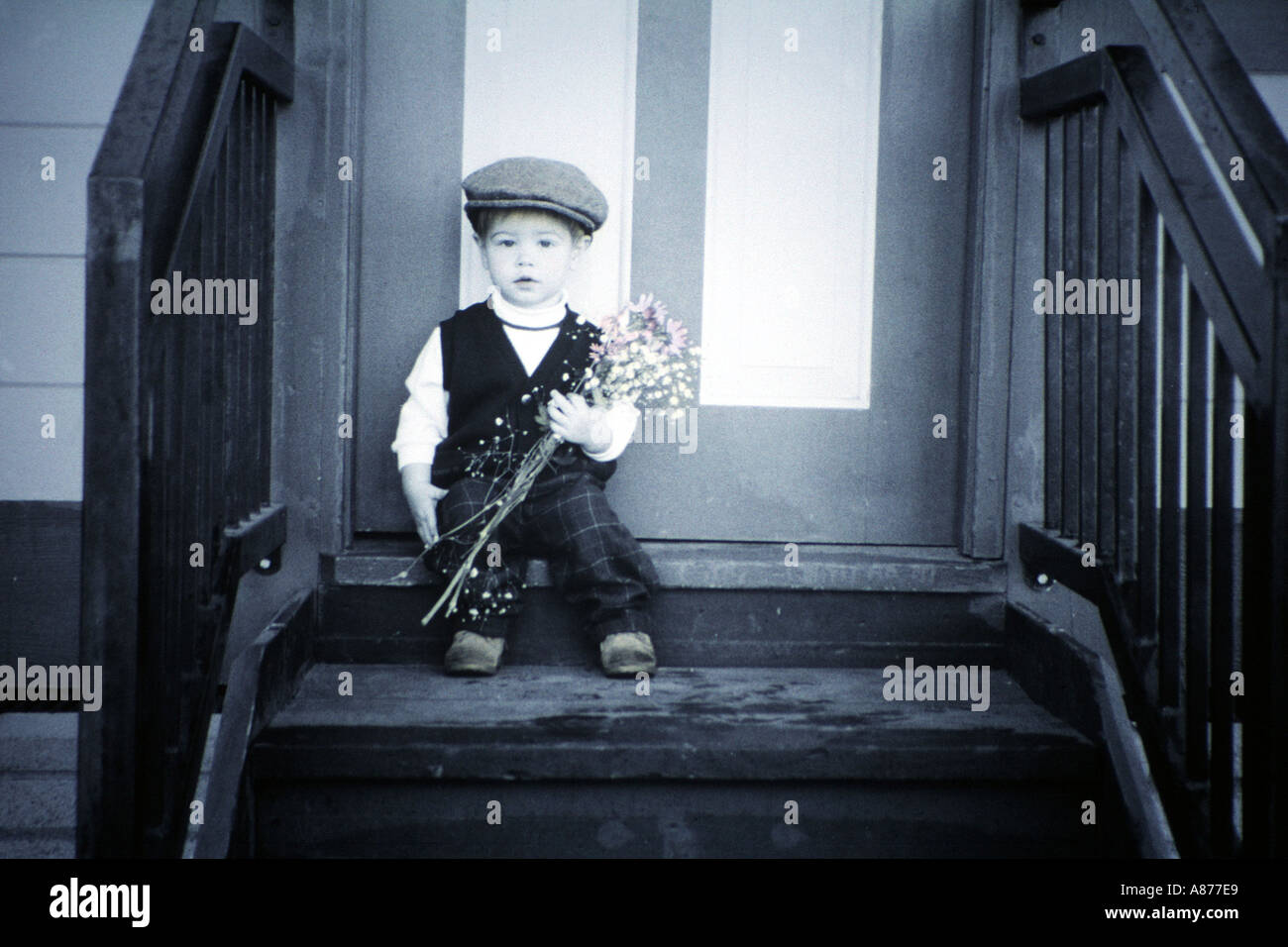 Little boy sits on the stoop Stock Photo - Alamy
