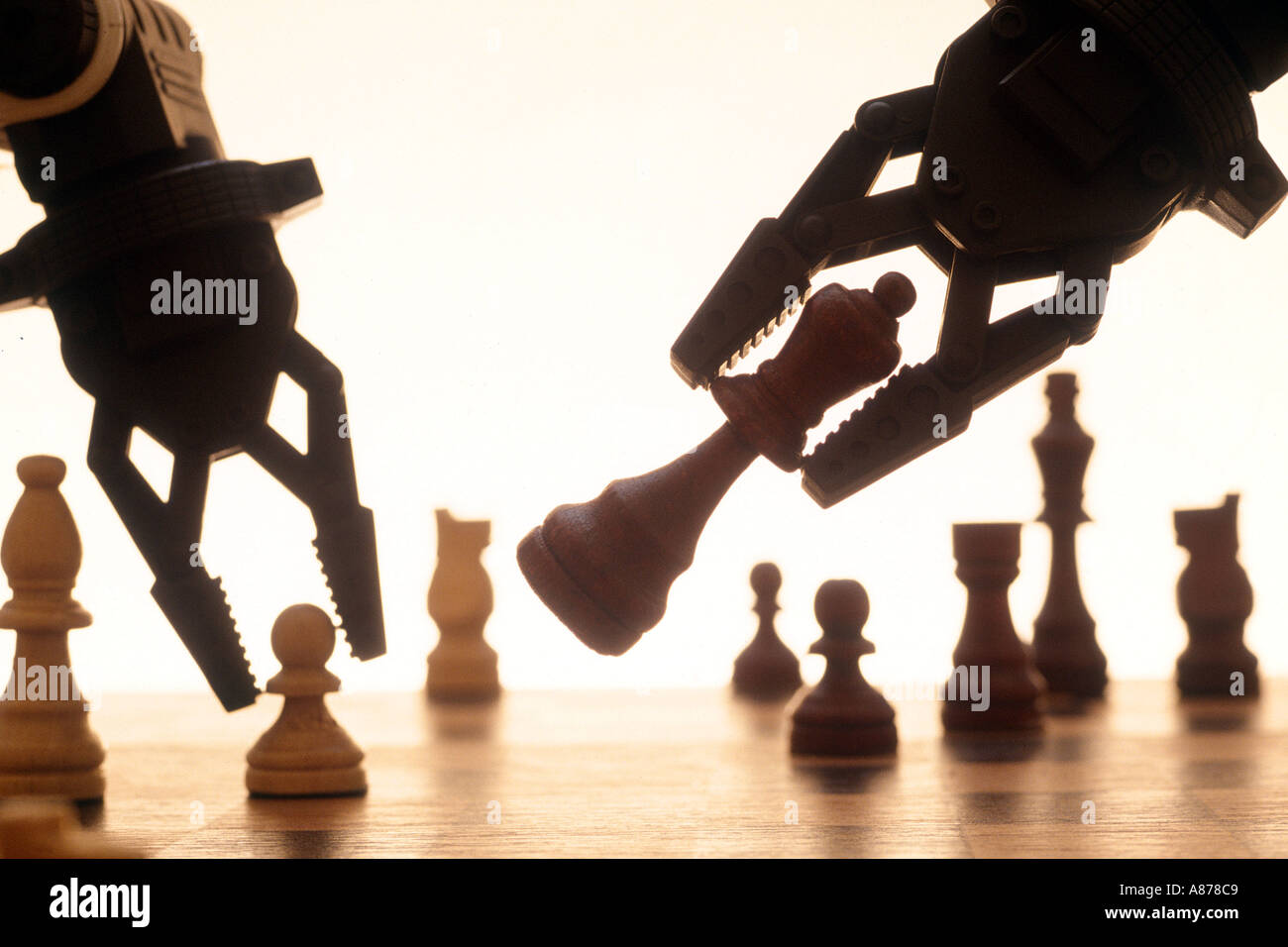 Mechanical robot arms move chess pieces on a chess board Stock Photo ...