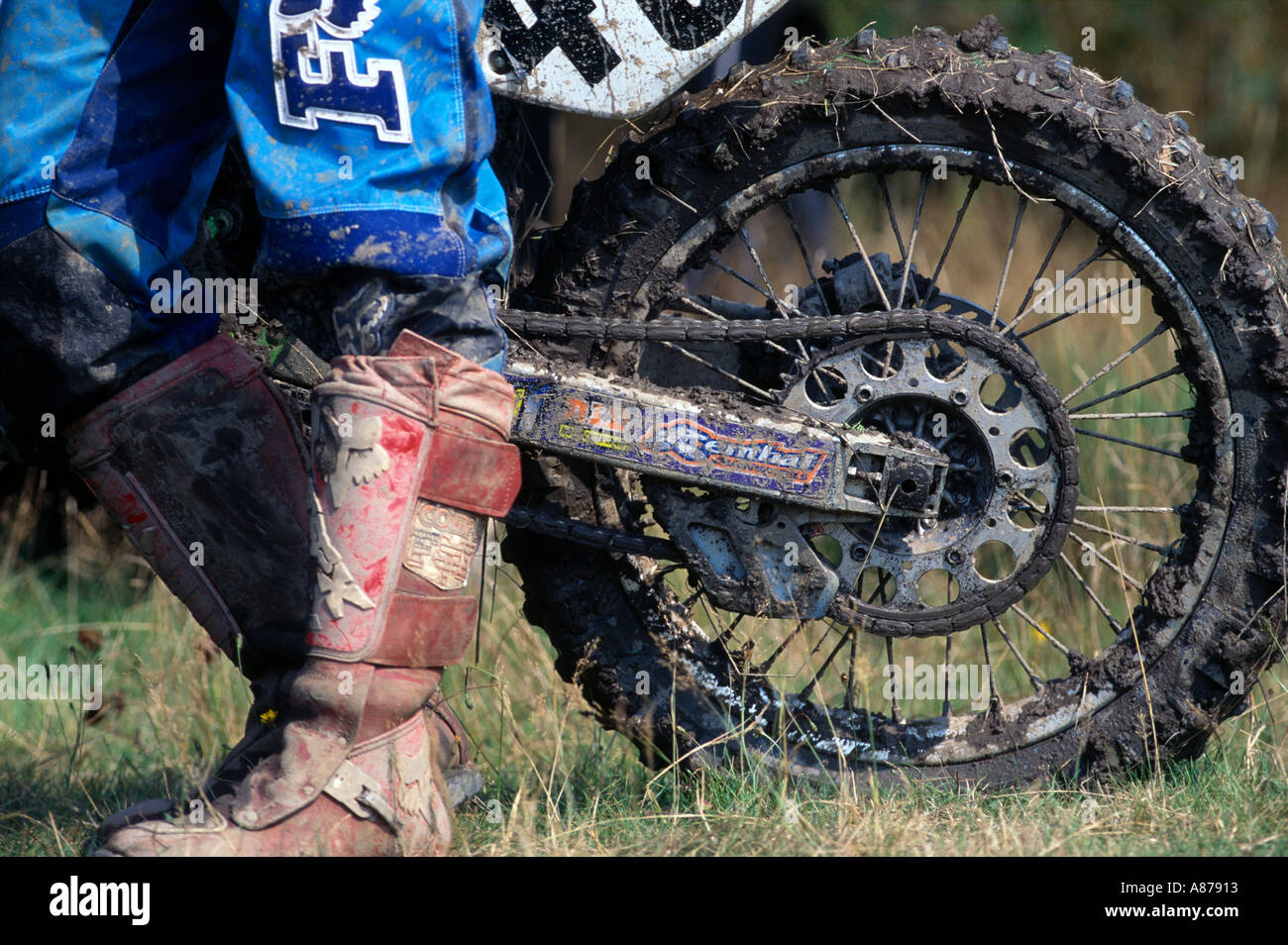 Mud encrusted motox boot and motorcycle Stock Photo - Alamy