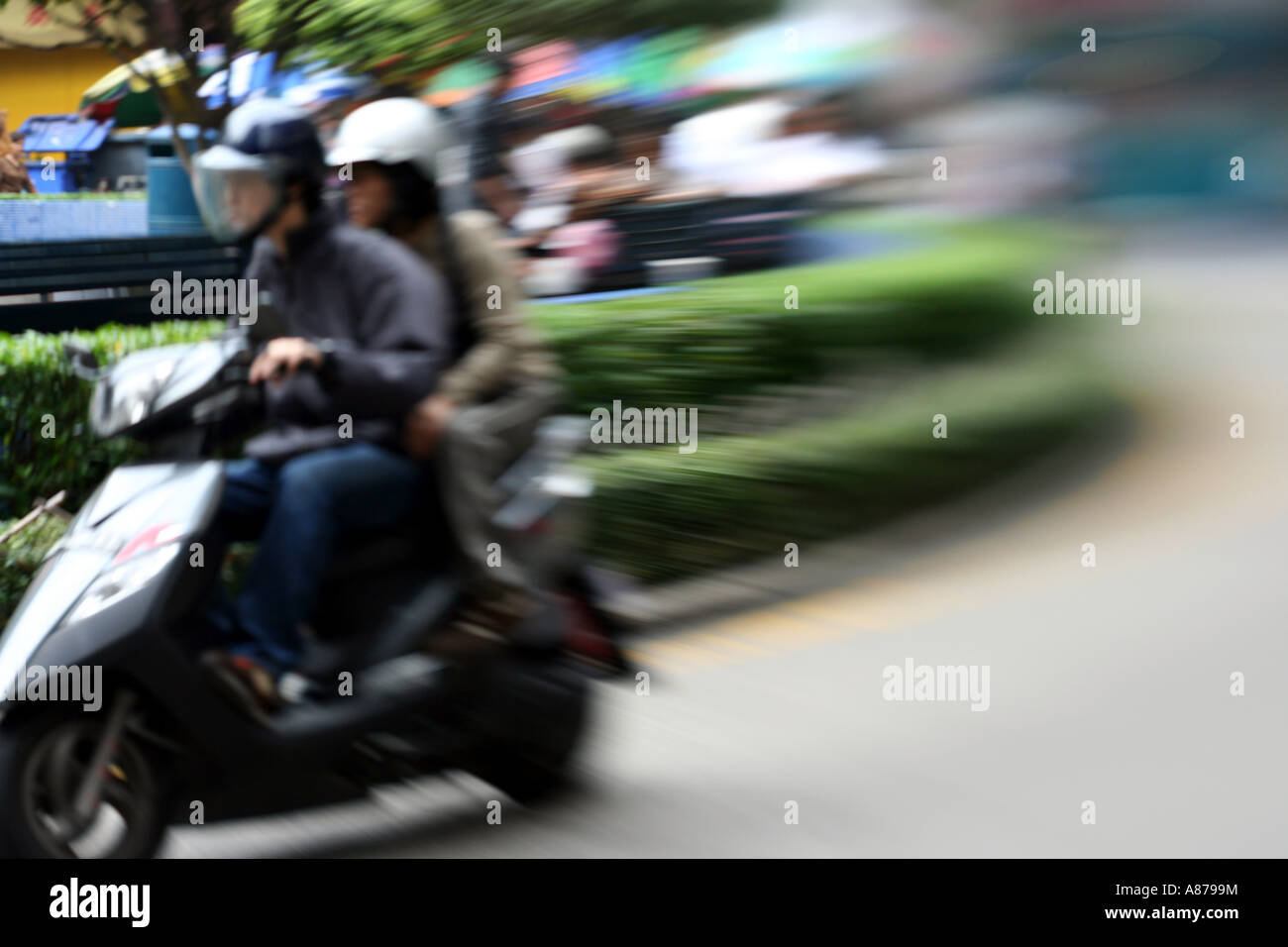 Scooter speeding on the road, Macau Stock Photo - Alamy