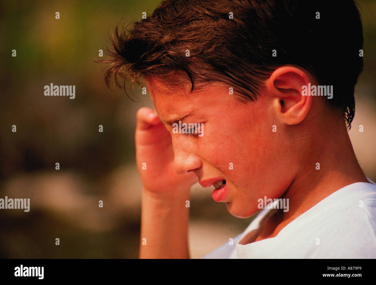 Portrait of a young boy crying with a distraught look on his face Stock ...