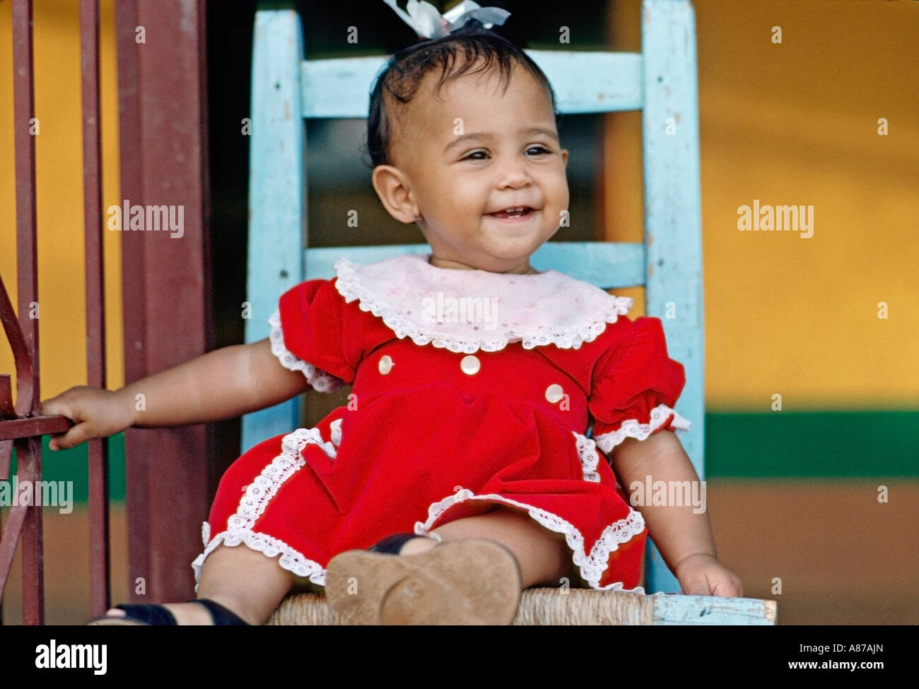 Portrait of a Dominican toddler in front of her home in northern ...