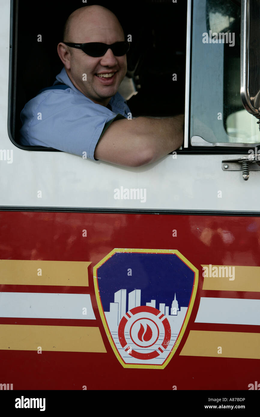 Fireman sitting in a fire truck Stock Photo - Alamy