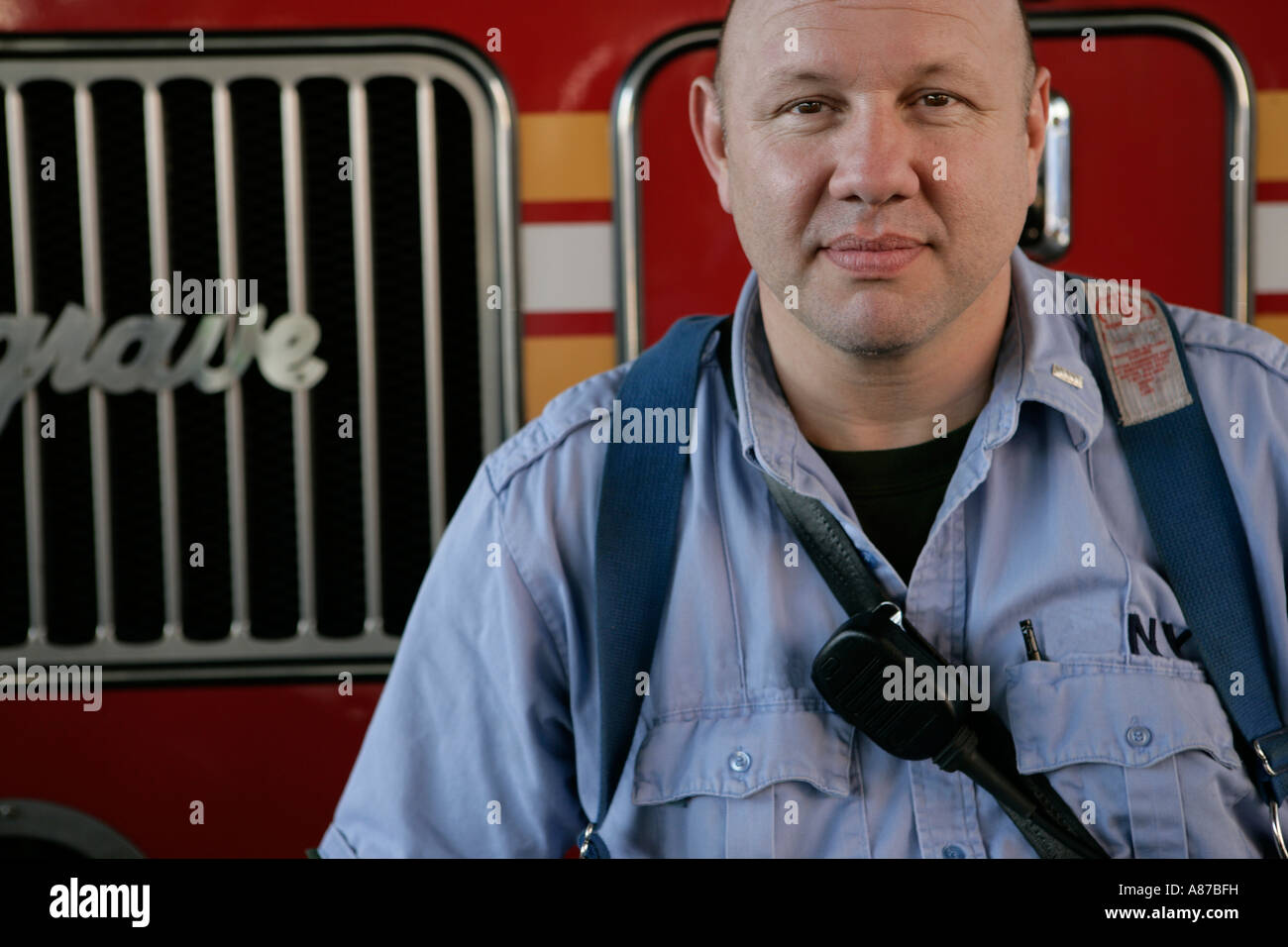 Fireman sitting on a fire truck Stock Photo - Alamy