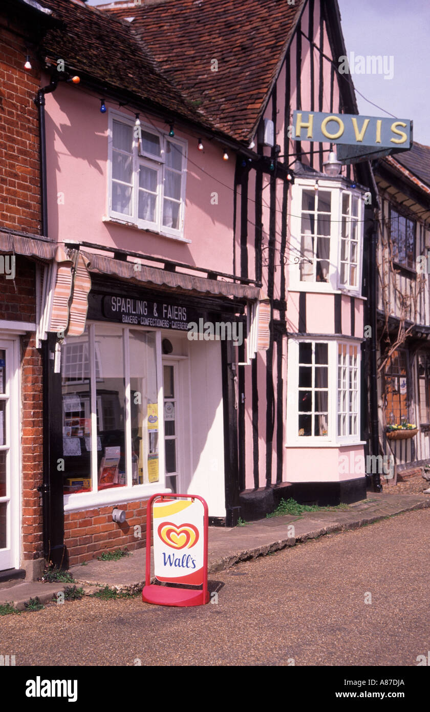 Timber framed buildings and village shops with Hovis sign on the market ...