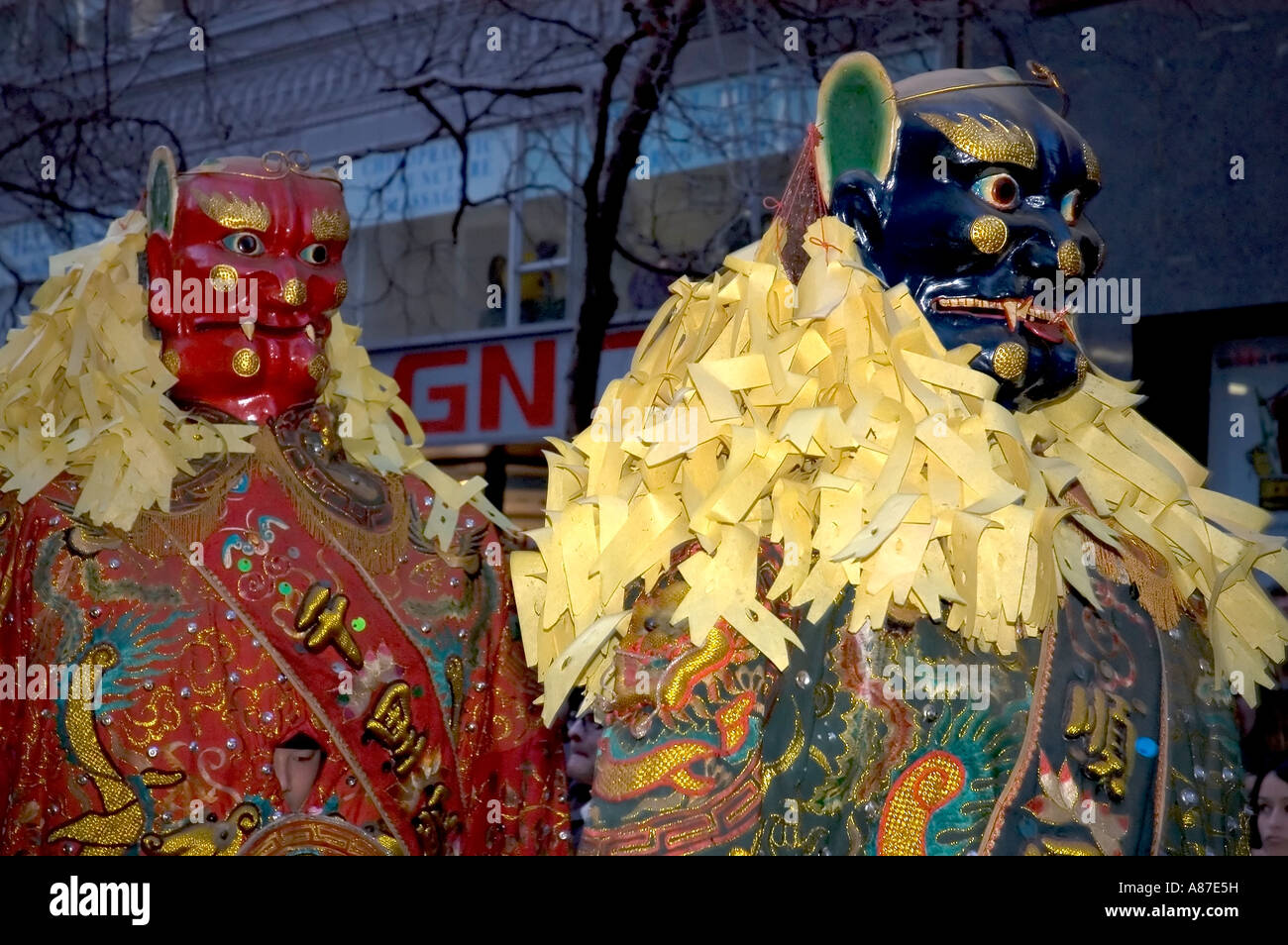 Two large, fierce-looking statues with red and black faces and gold ...