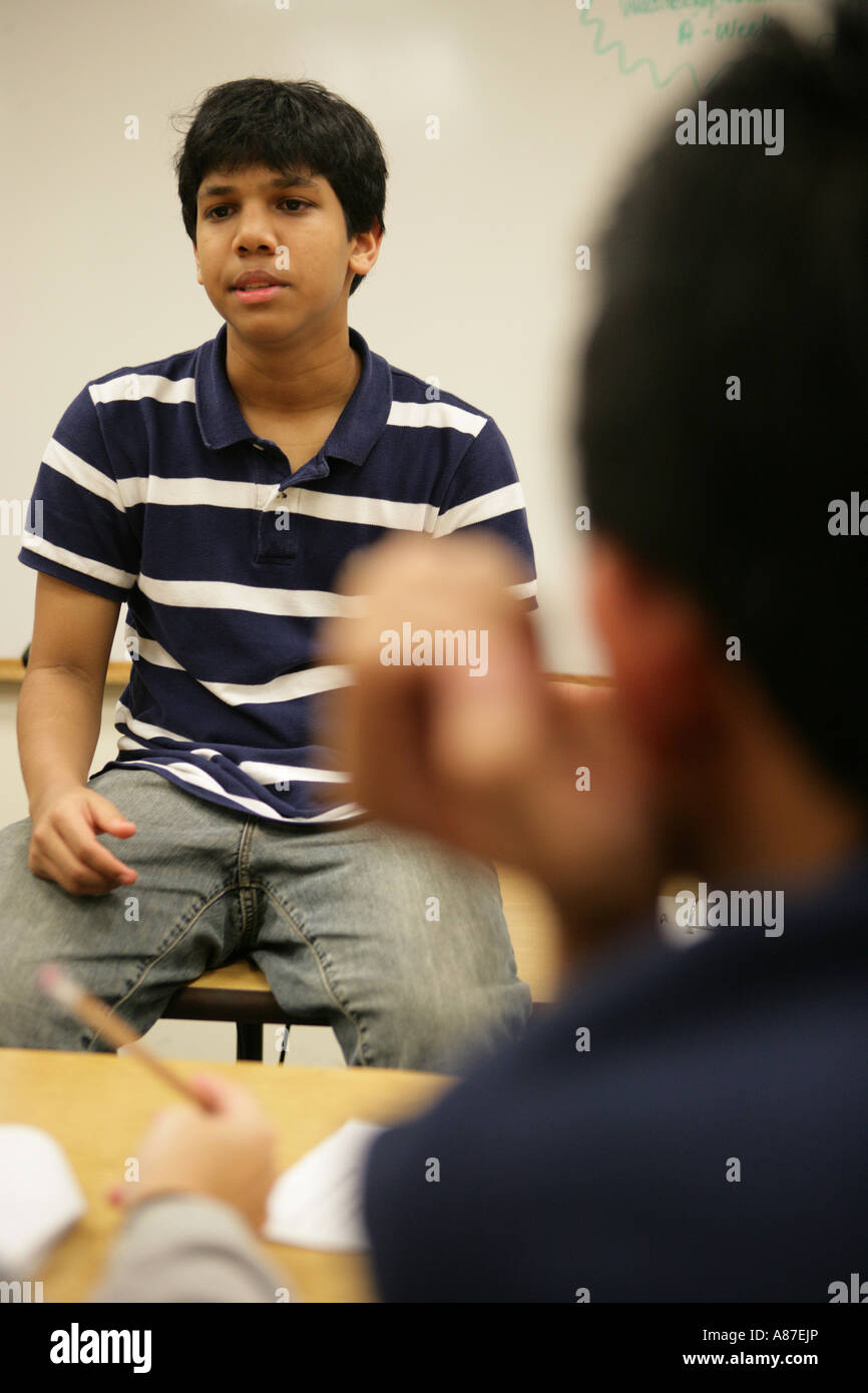 Boy (15-17) sitting on table Stock Photo - Alamy