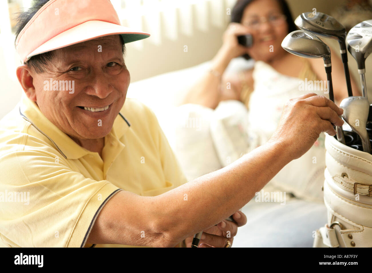 Senior man with golf club, smiling Stock Photo - Alamy