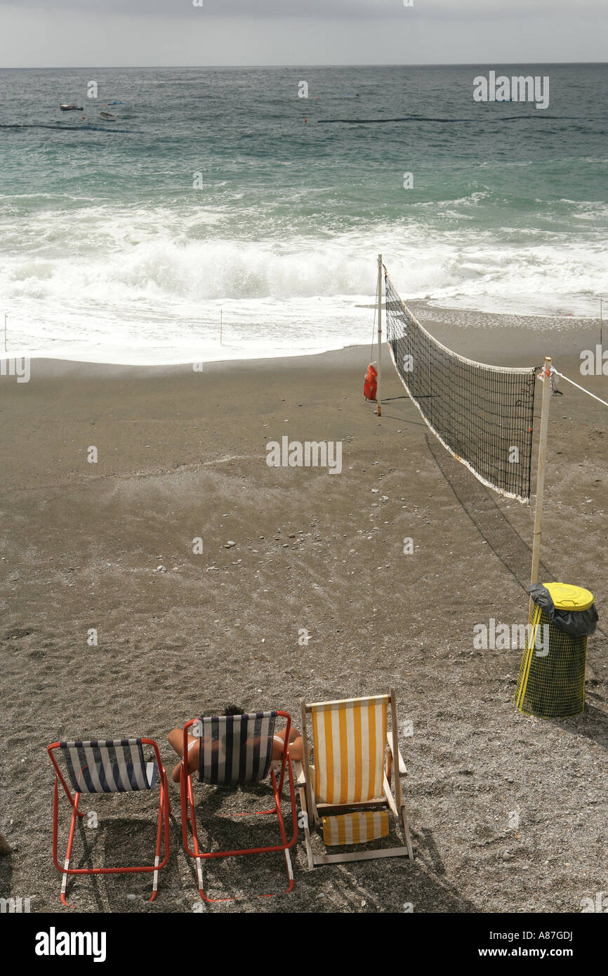Person relaxing on beach, elevated view Stock Photo - Alamy