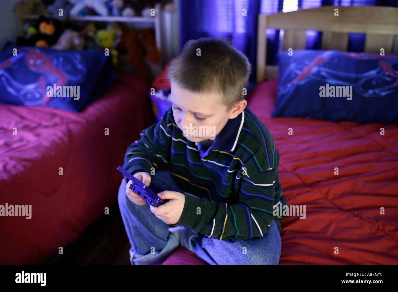Kids playing handheld video game hi-res stock photography and images ...