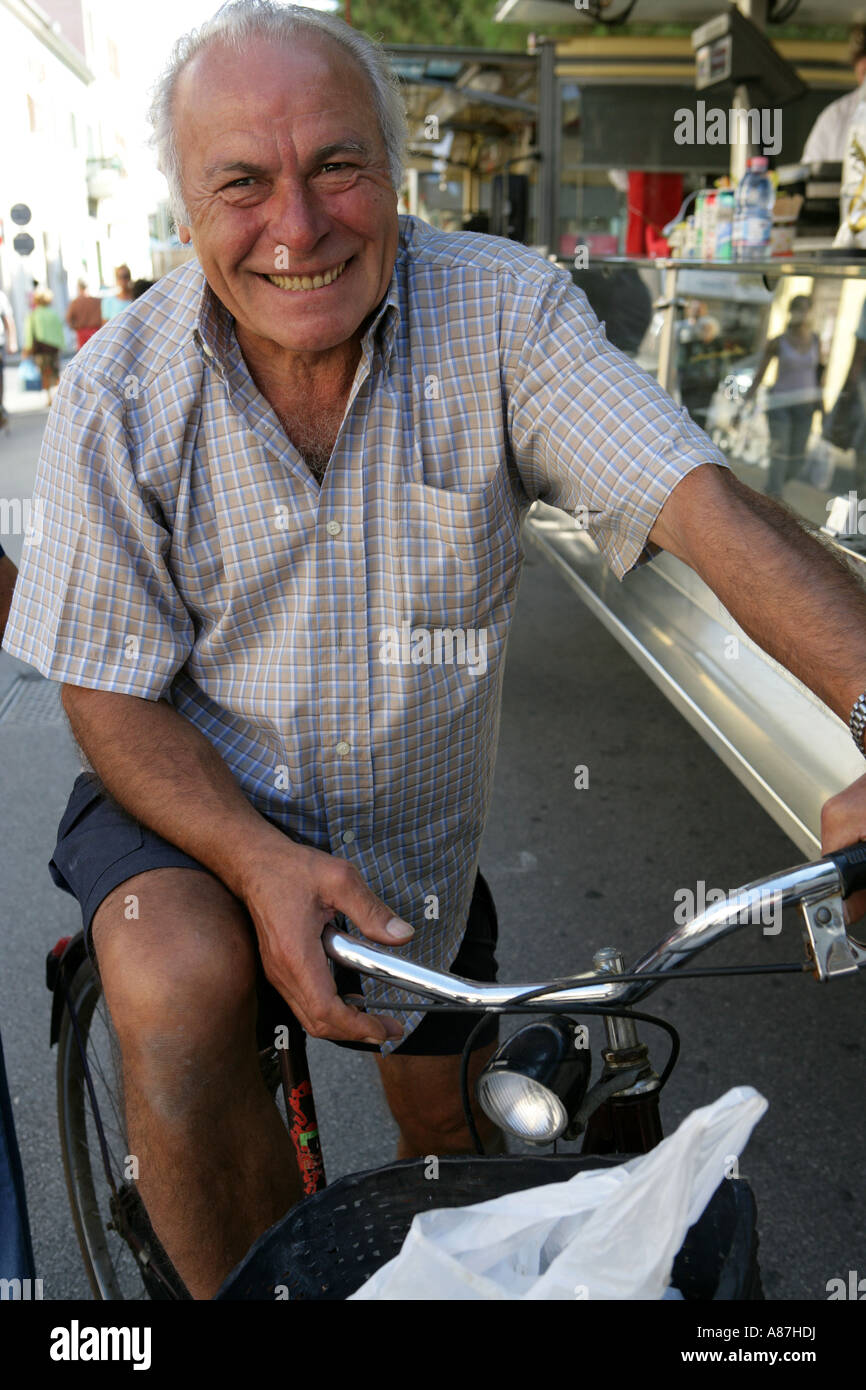 Senior man on bicycle, portrait Stock Photo - Alamy