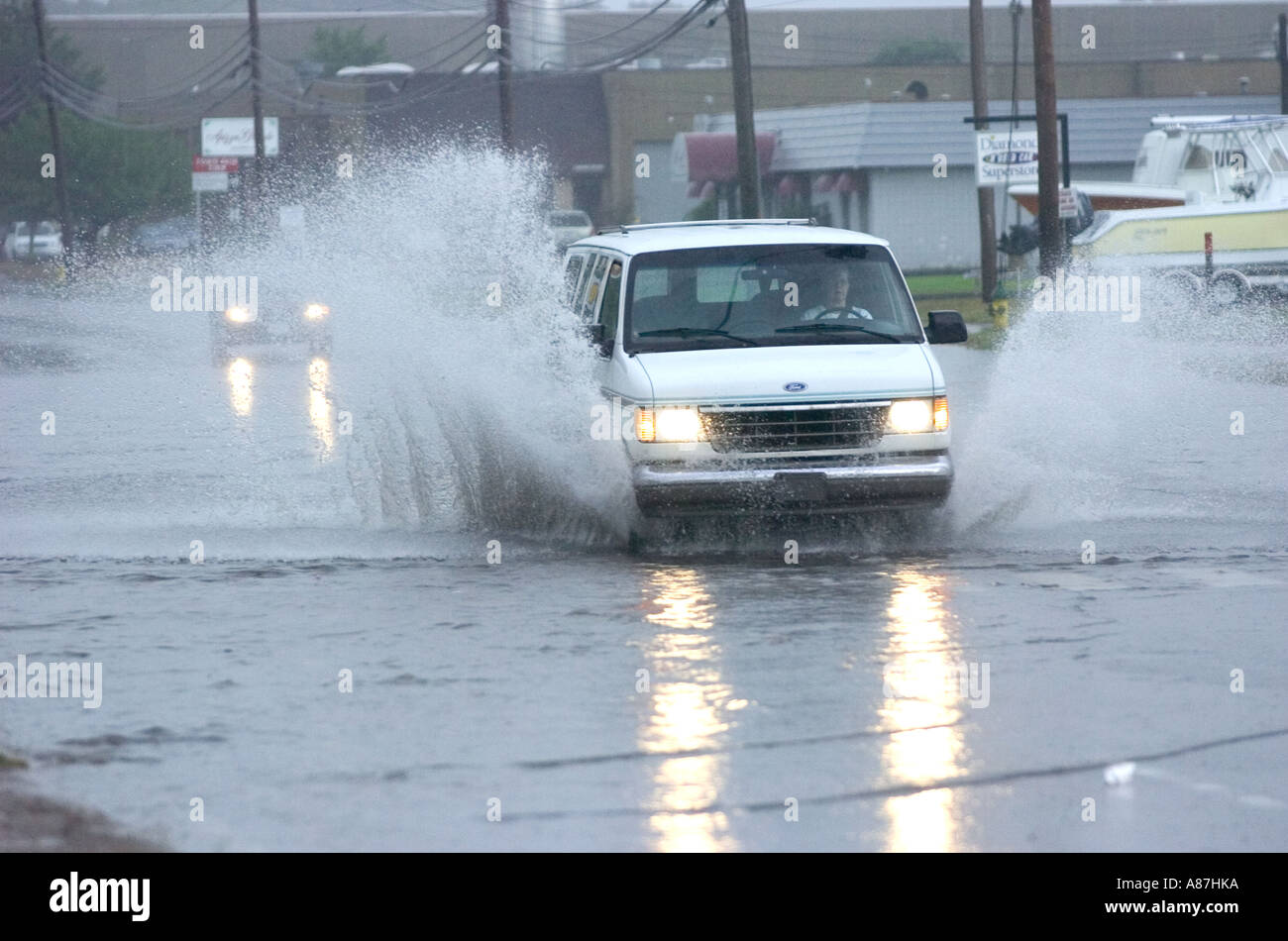 Van driving through flooded roadway in New York City Stock Photo - Alamy