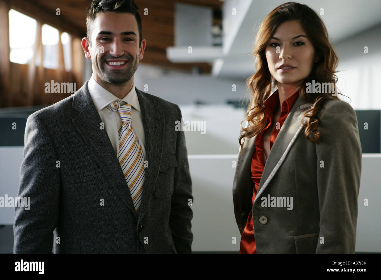Two business people looking at camera Stock Photo - Alamy