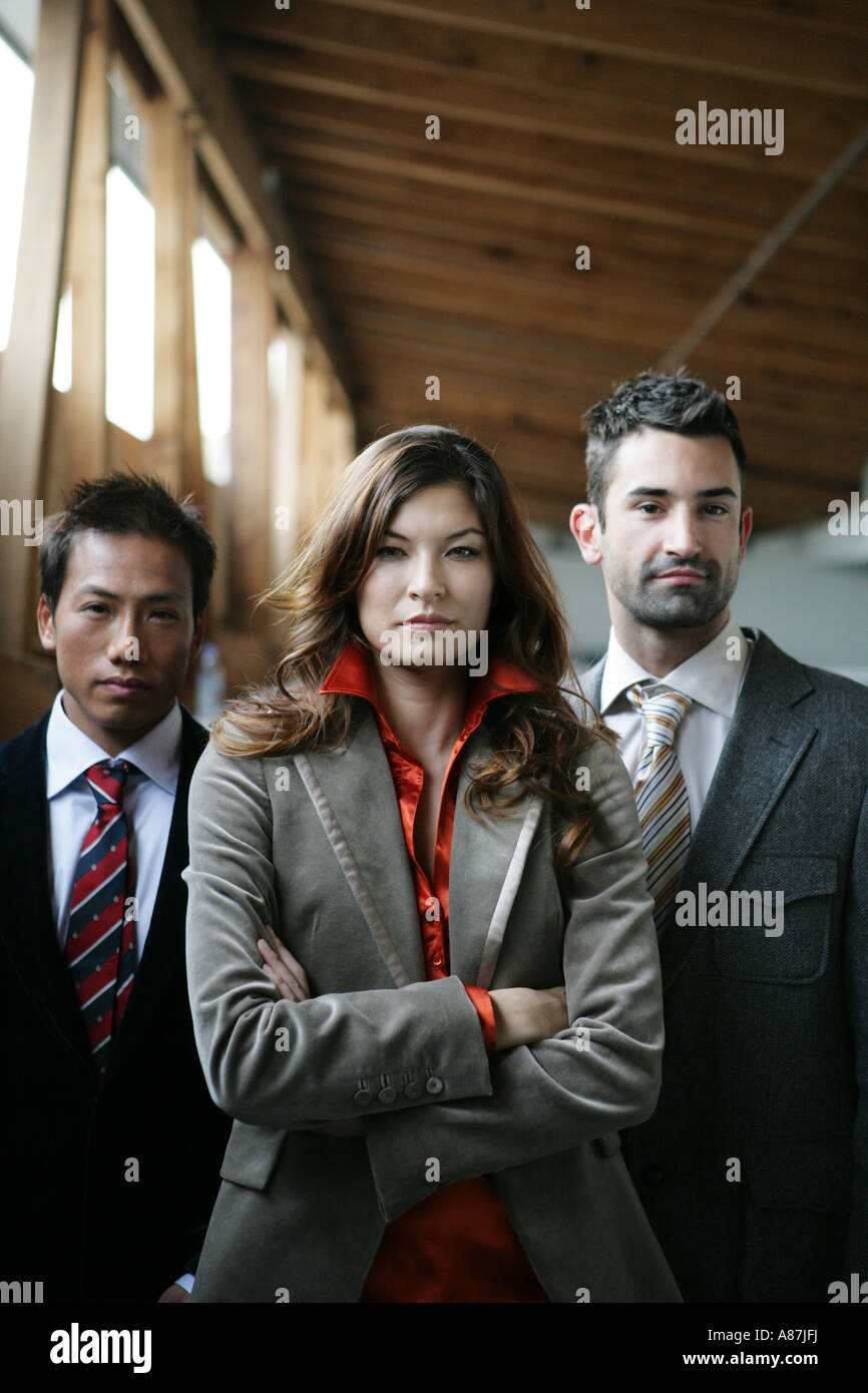 Three business people looking at camera Stock Photo - Alamy